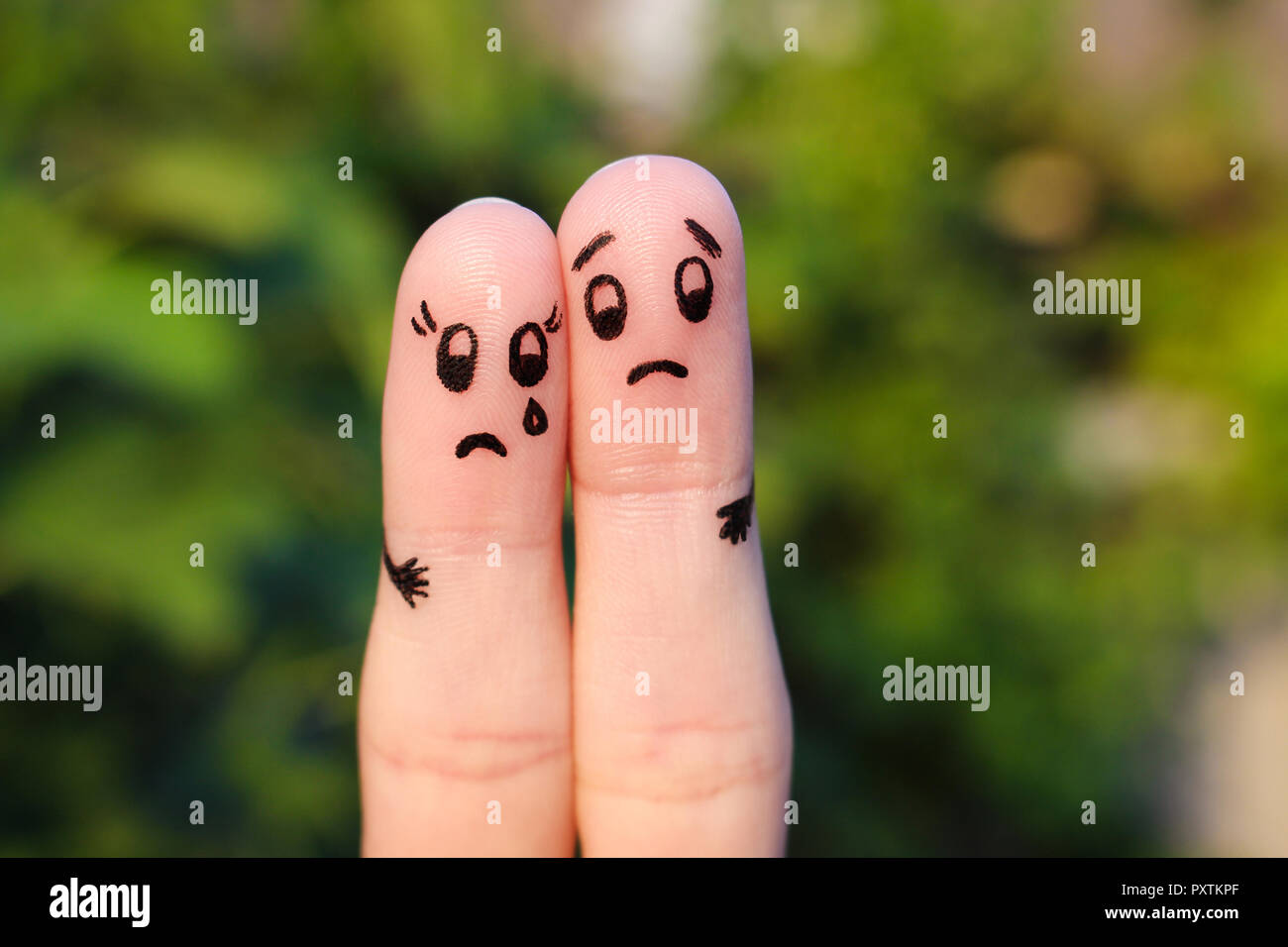 Finger art of displeased couple. Sad man soothe woman, she's crying ...