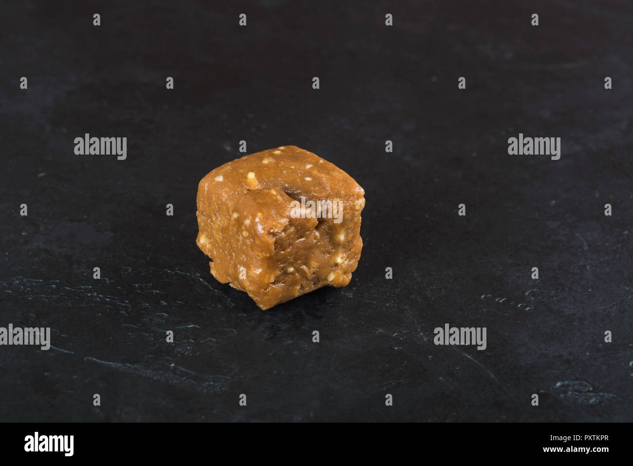 One piece of fudge over black background with copy space Stock Photo ...