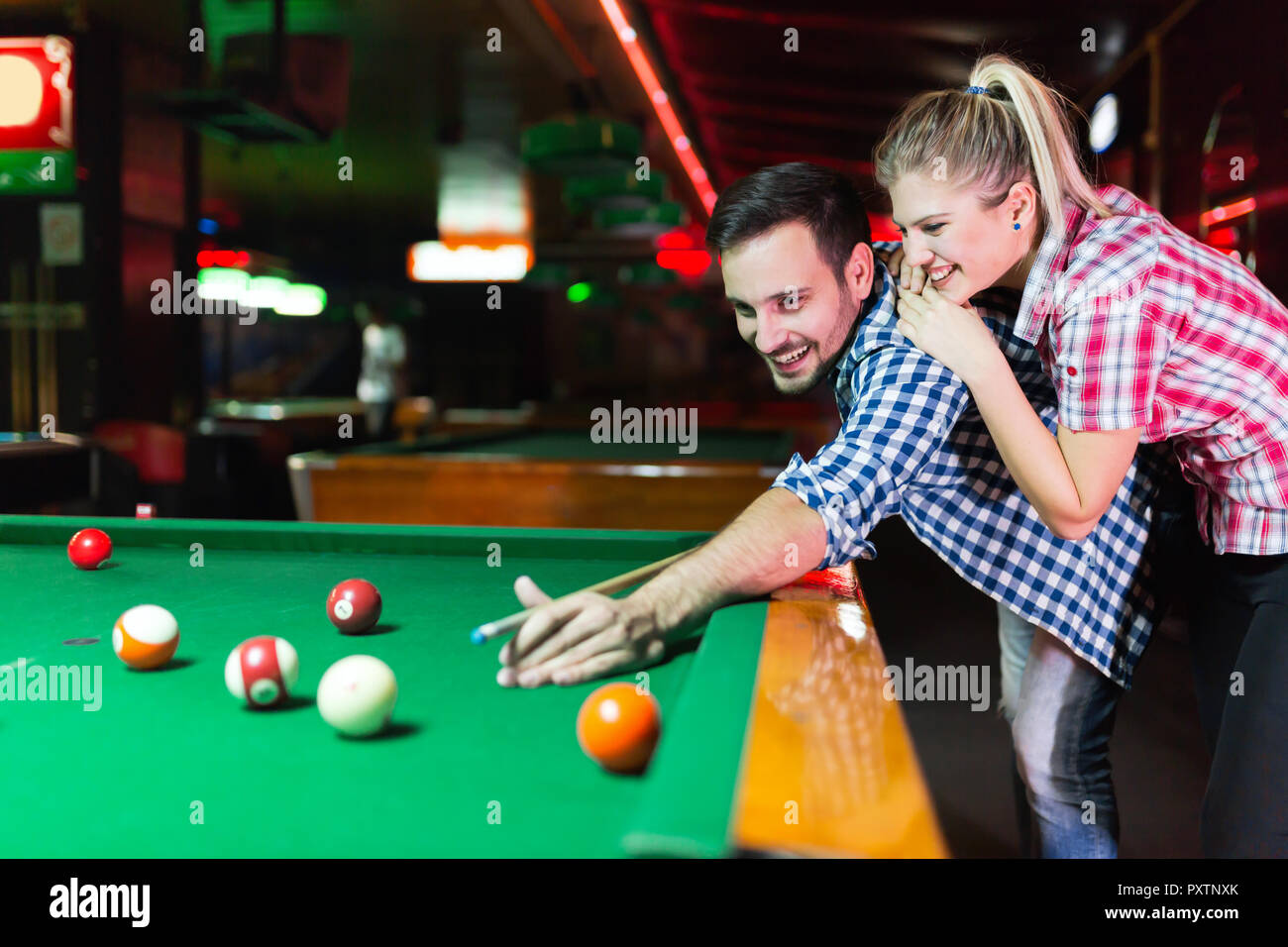 Two women shooting pool hi-res stock photography and images - Alamy