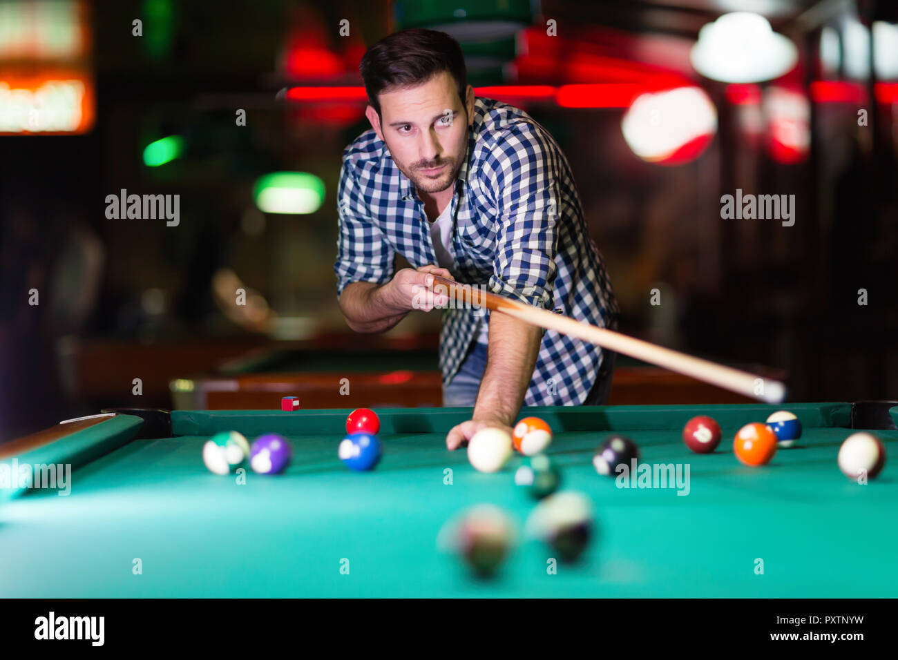Hansome man playing pool in bar alone Stock Photo - Alamy