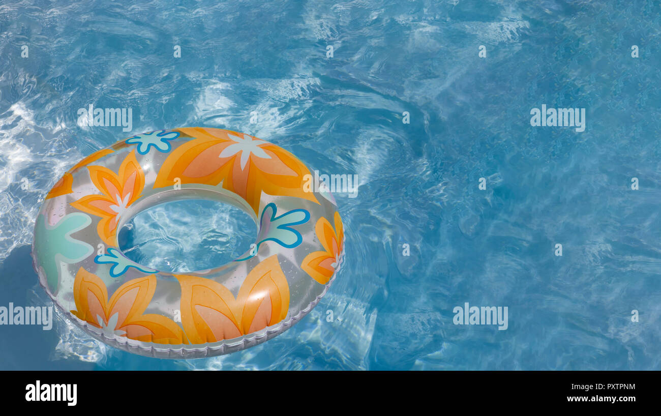 Colorful toy swimming tire at the pool, blue water Stock Photo - Alamy