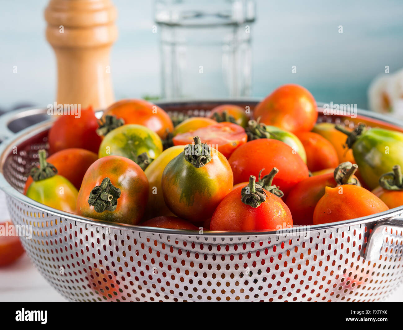 Italian tomatoes in a colander on table. Cooking with tomatoes concept ...