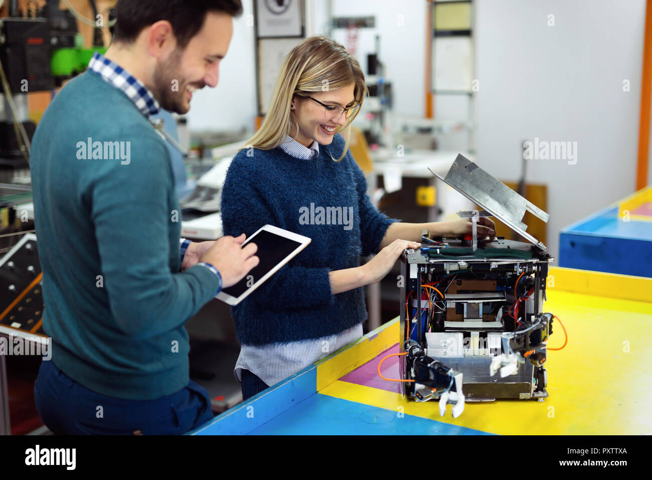 Young attractive students of mechatronics working on project Stock ...