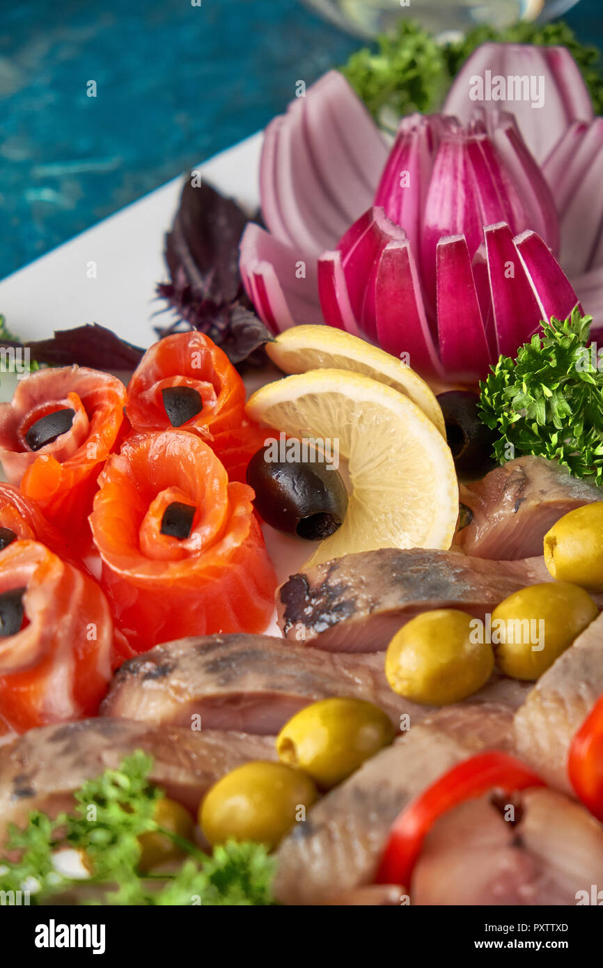 Plate with fish platter on blue background 1 Stock Photo - Alamy