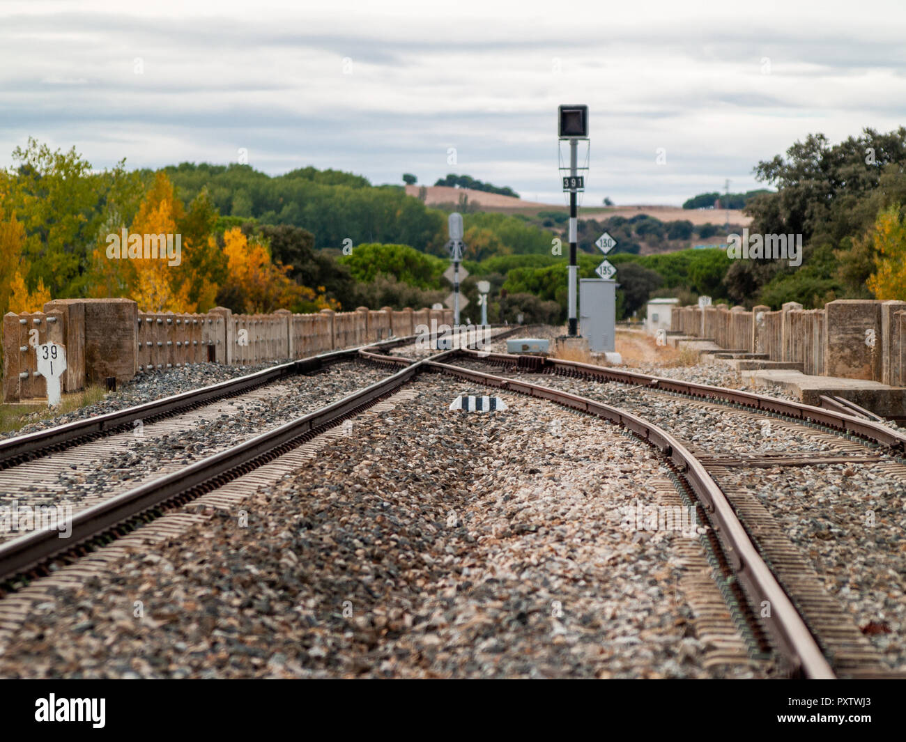 Crossroads on train tracks that go through a landscape in autumn with ...