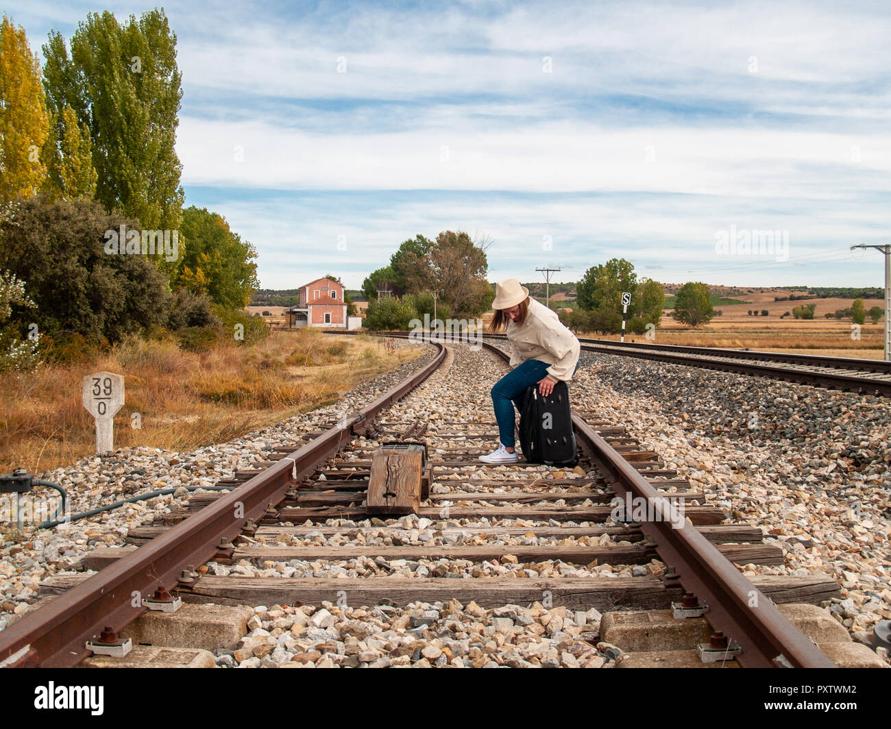 Woman sitting on railroad tracks hi-res stock photography and images ...
