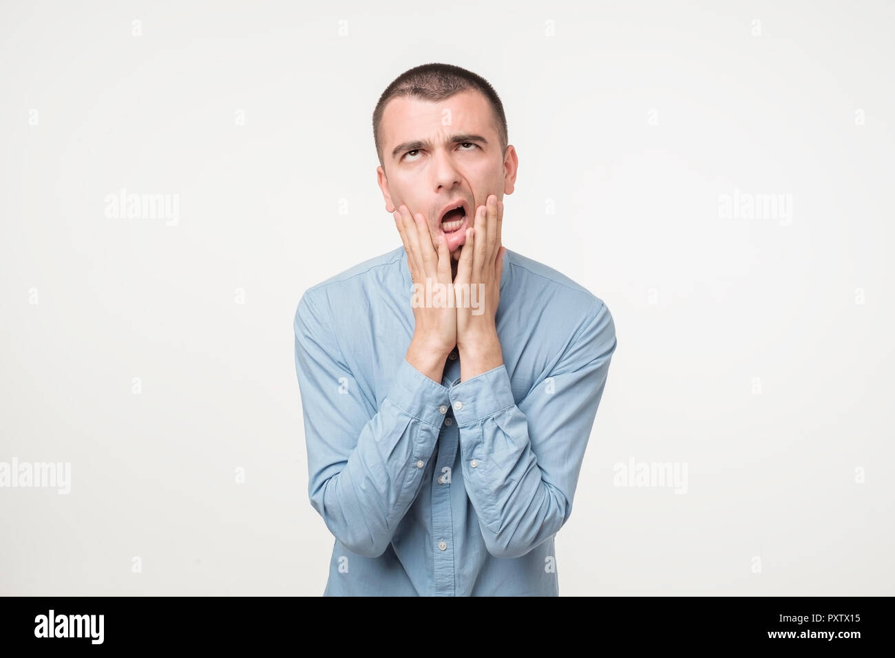 Sleepy man yawning in studio hi-res stock photography and images - Alamy