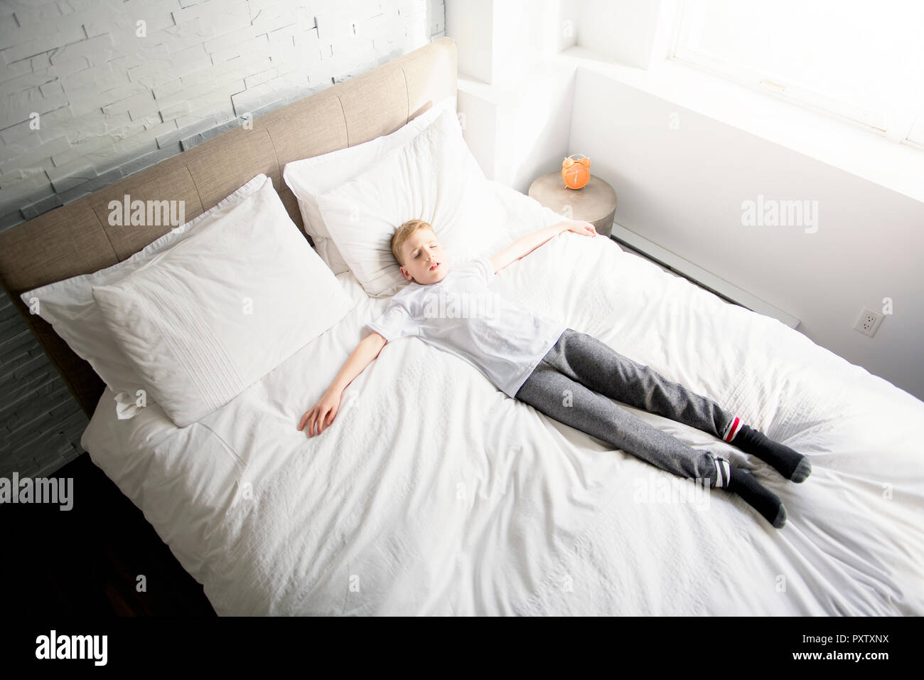 child portrait in white bed like tired Stock Photo - Alamy