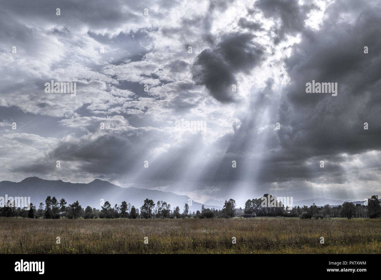 Sunbeams breaking through clouds Stock Photo - Alamy