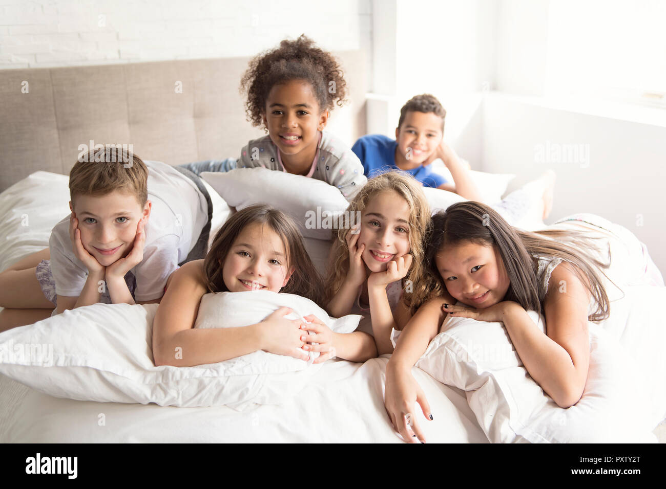 large group of her friends taking goog time on bed Stock Photo - Alamy