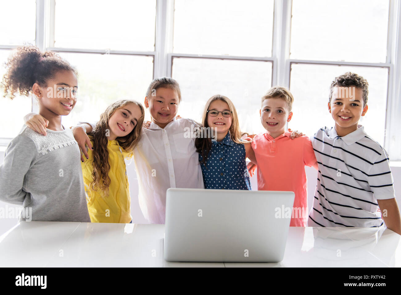 A Group of curious children watching stuff on the laptop screen Stock ...