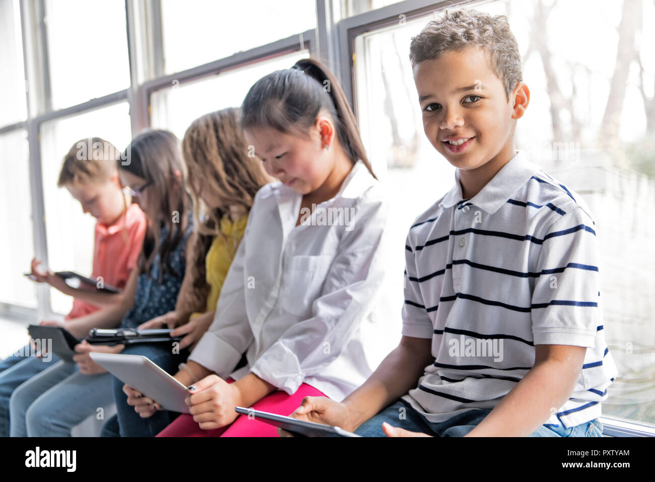 A Group of curious children watching stuff on the tablet screen Stock ...