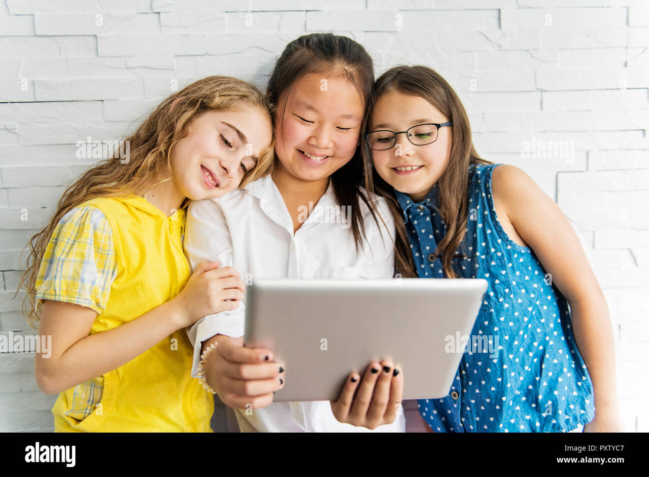 A Group of curious children watching stuff on the tablet screen Stock ...
