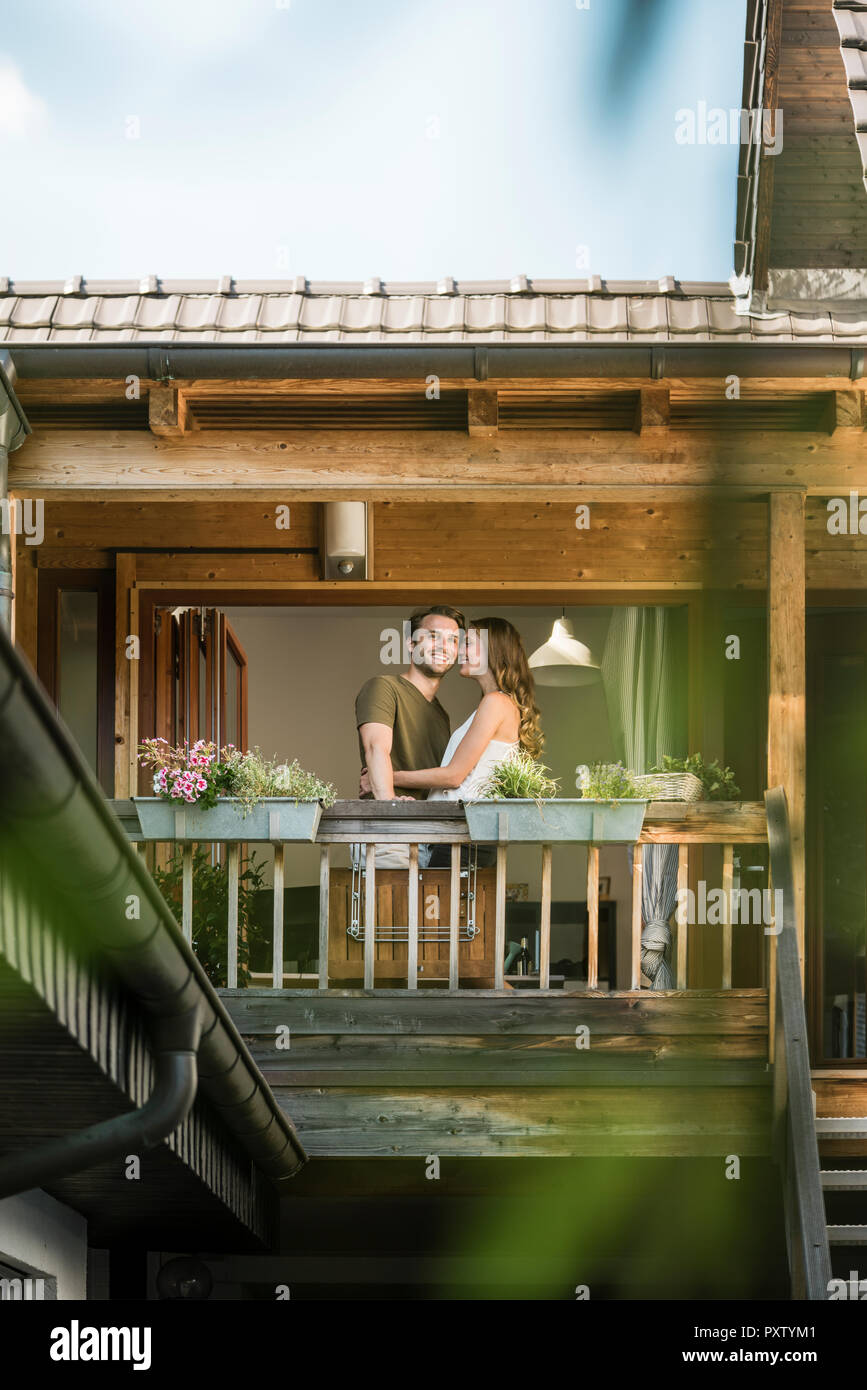 Happy affectionate couple on balcony at home Stock Photo - Alamy