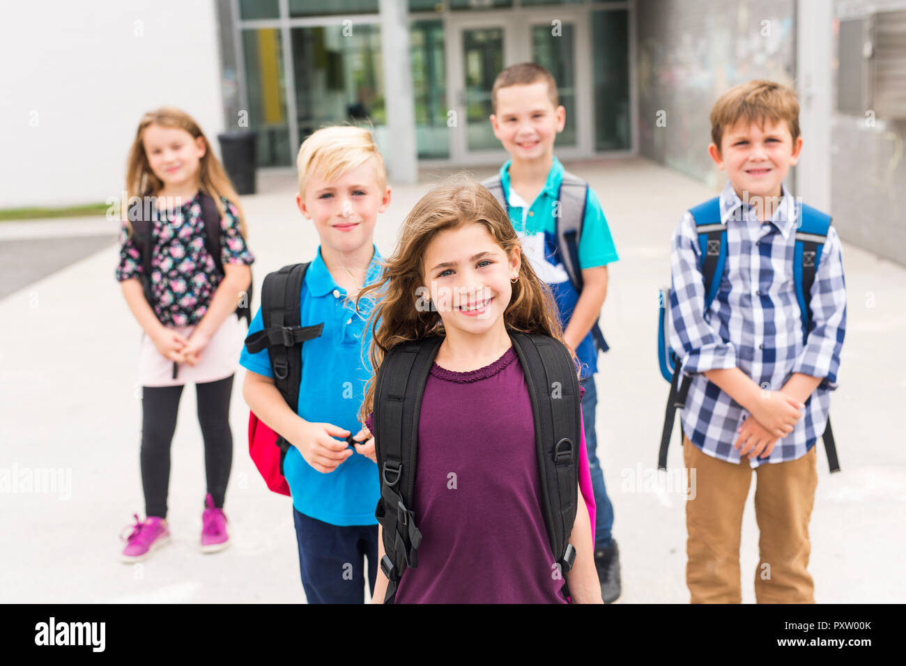 Great group Portrait Of School Pupil Outside Classroom Carrying Bags ...