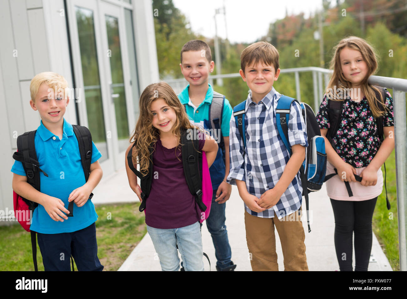 Great group Portrait Of School Pupil Outside Classroom Carrying Bags ...