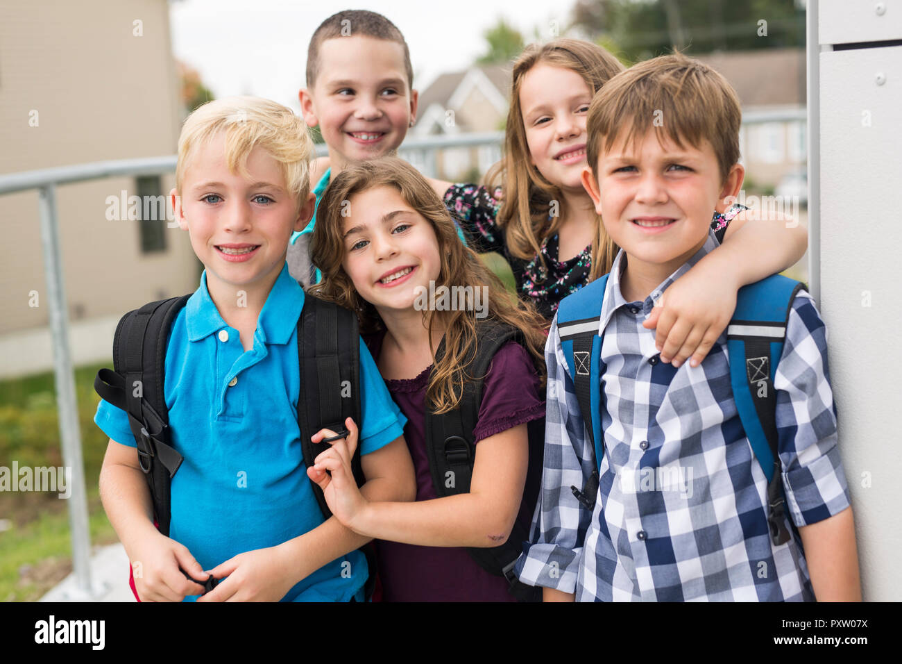 Great group Portrait Of School Pupil Outside Classroom Carrying Bags ...