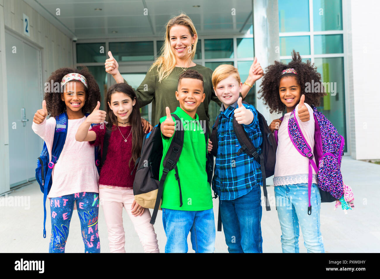 Pre teen school children with teacher outside Stock Photo - Alamy