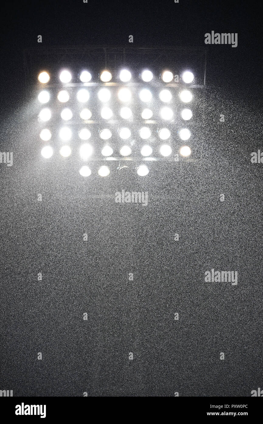 Raining in the stadium and spotlight Stock Photo - Alamy