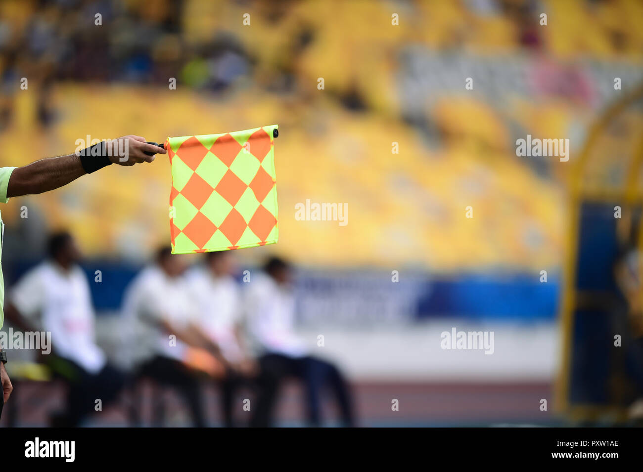 Assistant referee hold flag,offside signal Stock Photo - Alamy