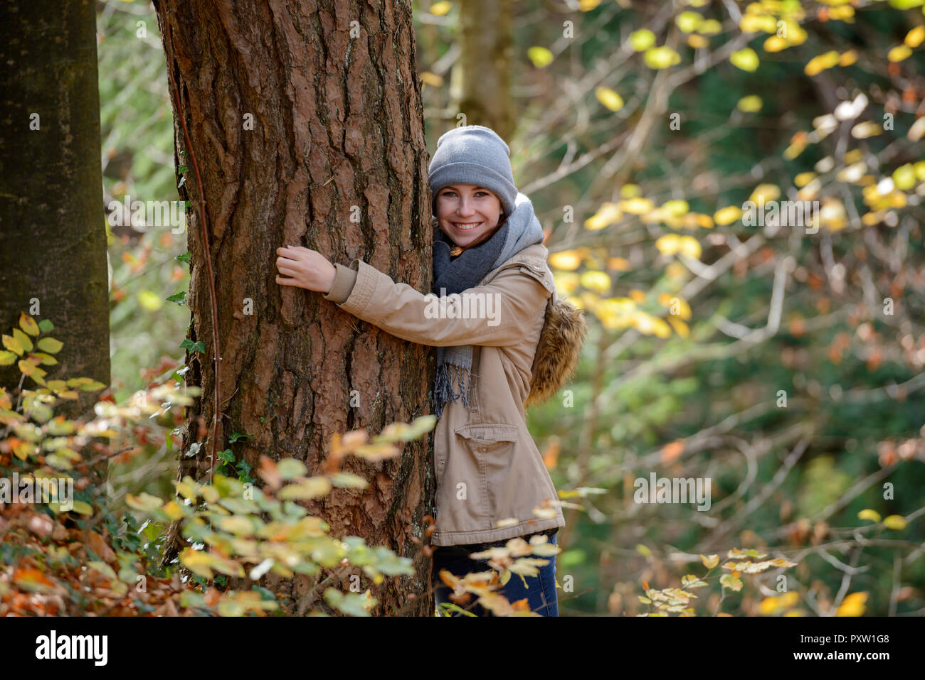 Portrait Smiling Teenage Girl Hugging Tree Trunk Autumnal Forest Hi Res