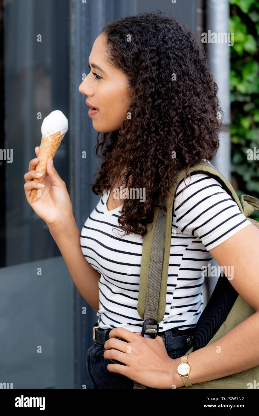 Woman eating ice cream in the city Stock Photo - Alamy