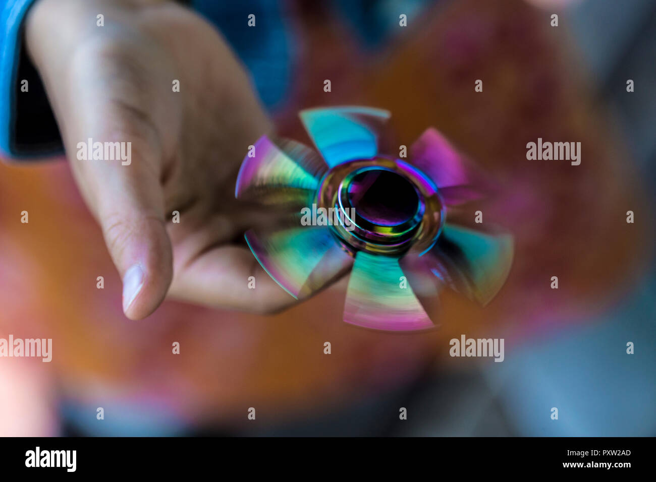 Hand of girl holding rotating Fidget Spinner Stock Photo - Alamy