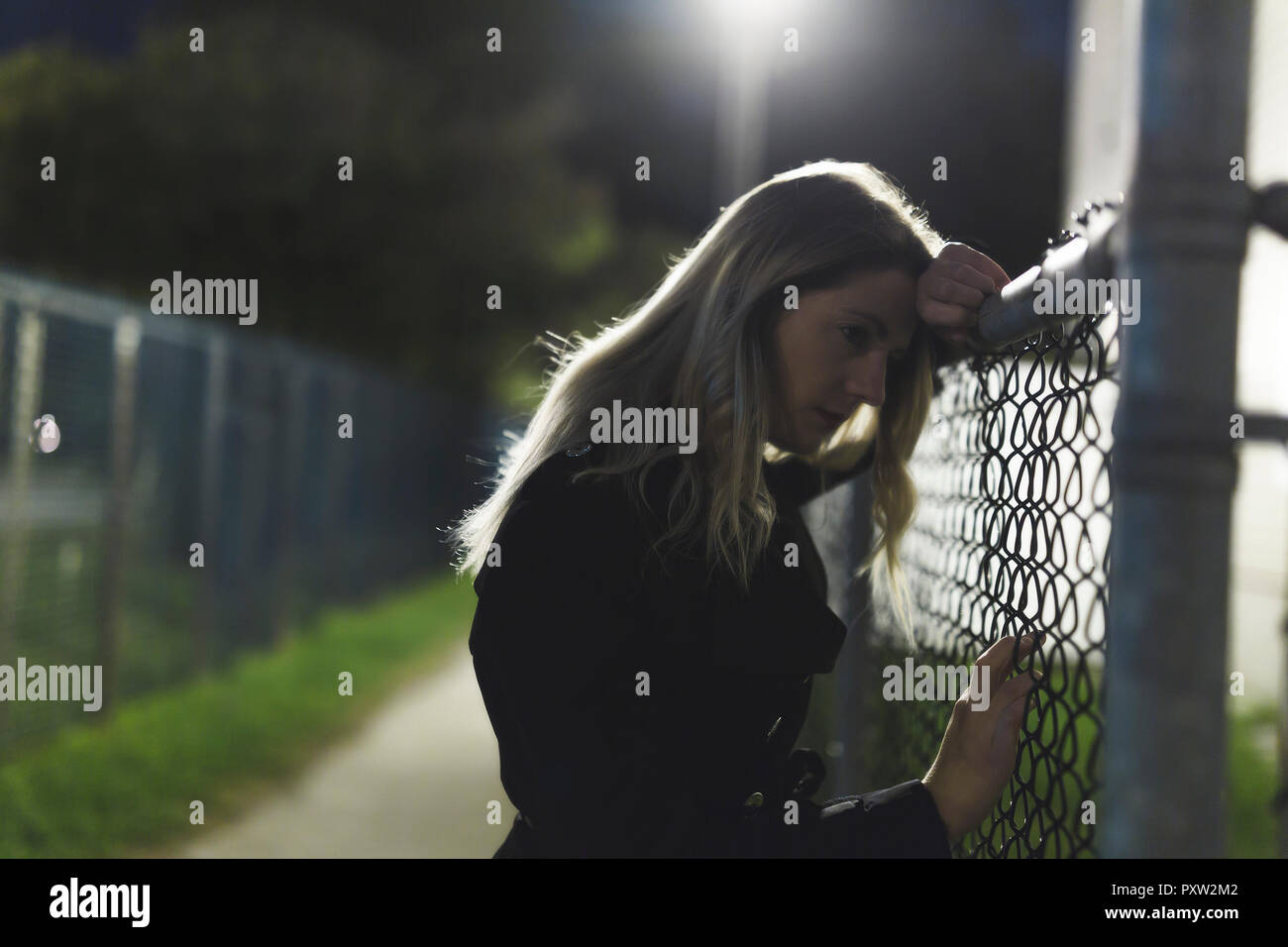 portrait of young sad woman at night Stock Photo - Alamy
