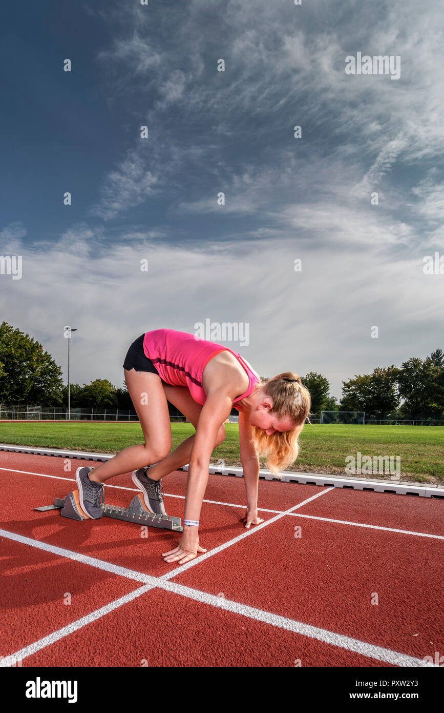 Female runner in starting position Stock Photo - Alamy
