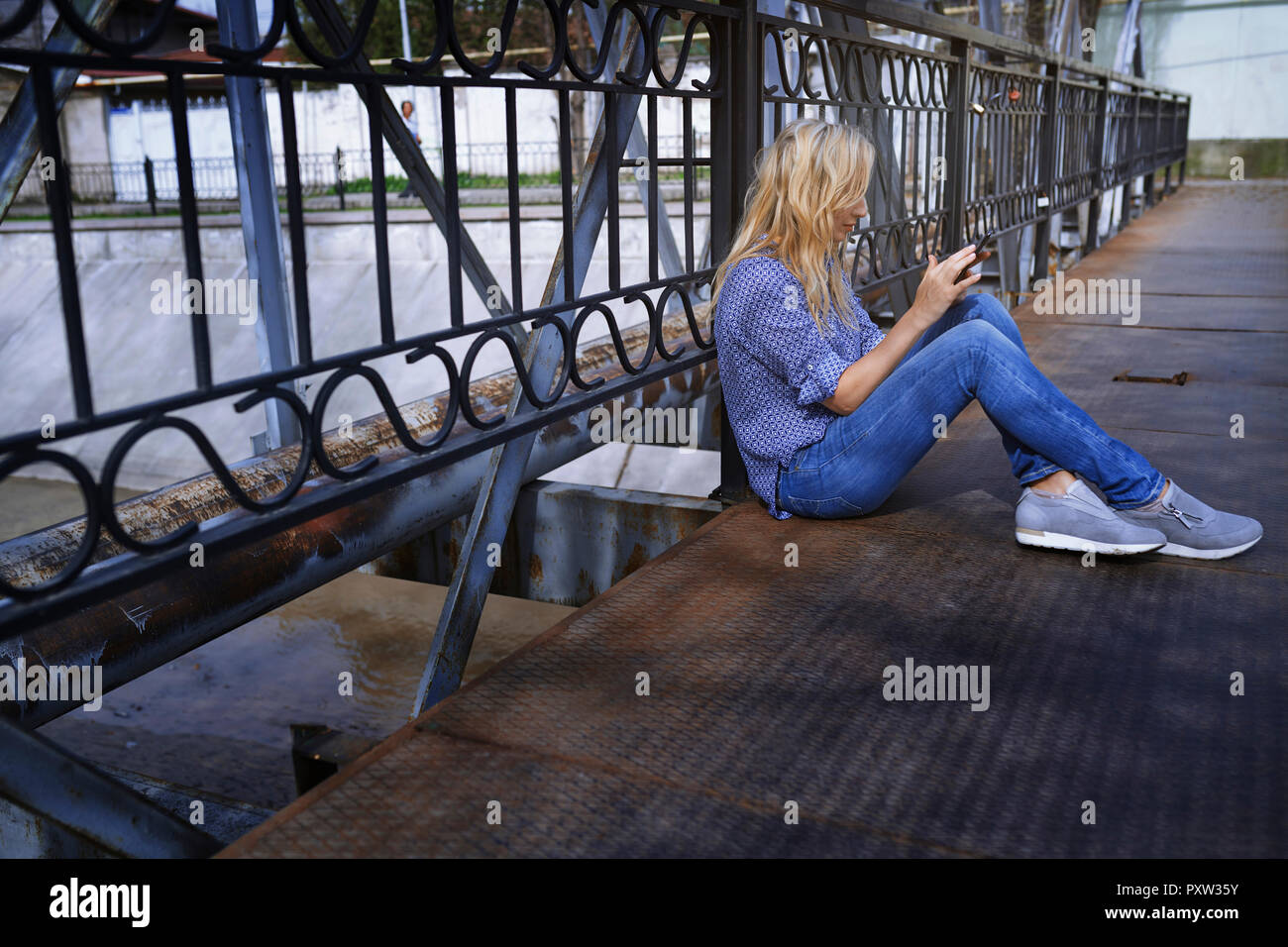 Blond woman sitting bridge hi-res stock photography and images - Alamy