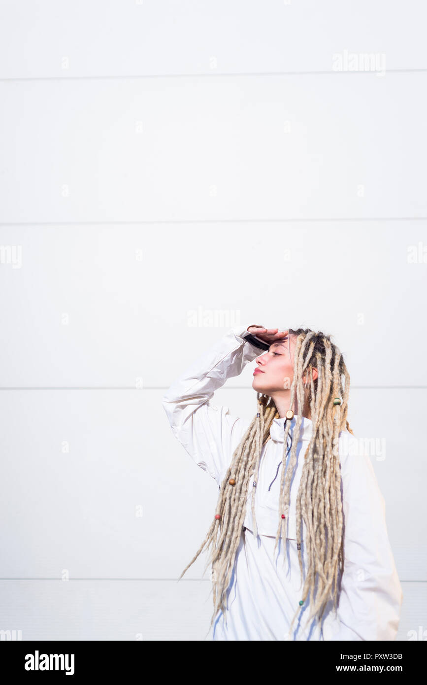 Futuristic fashionable young woman shading her eyes from sun Stock ...