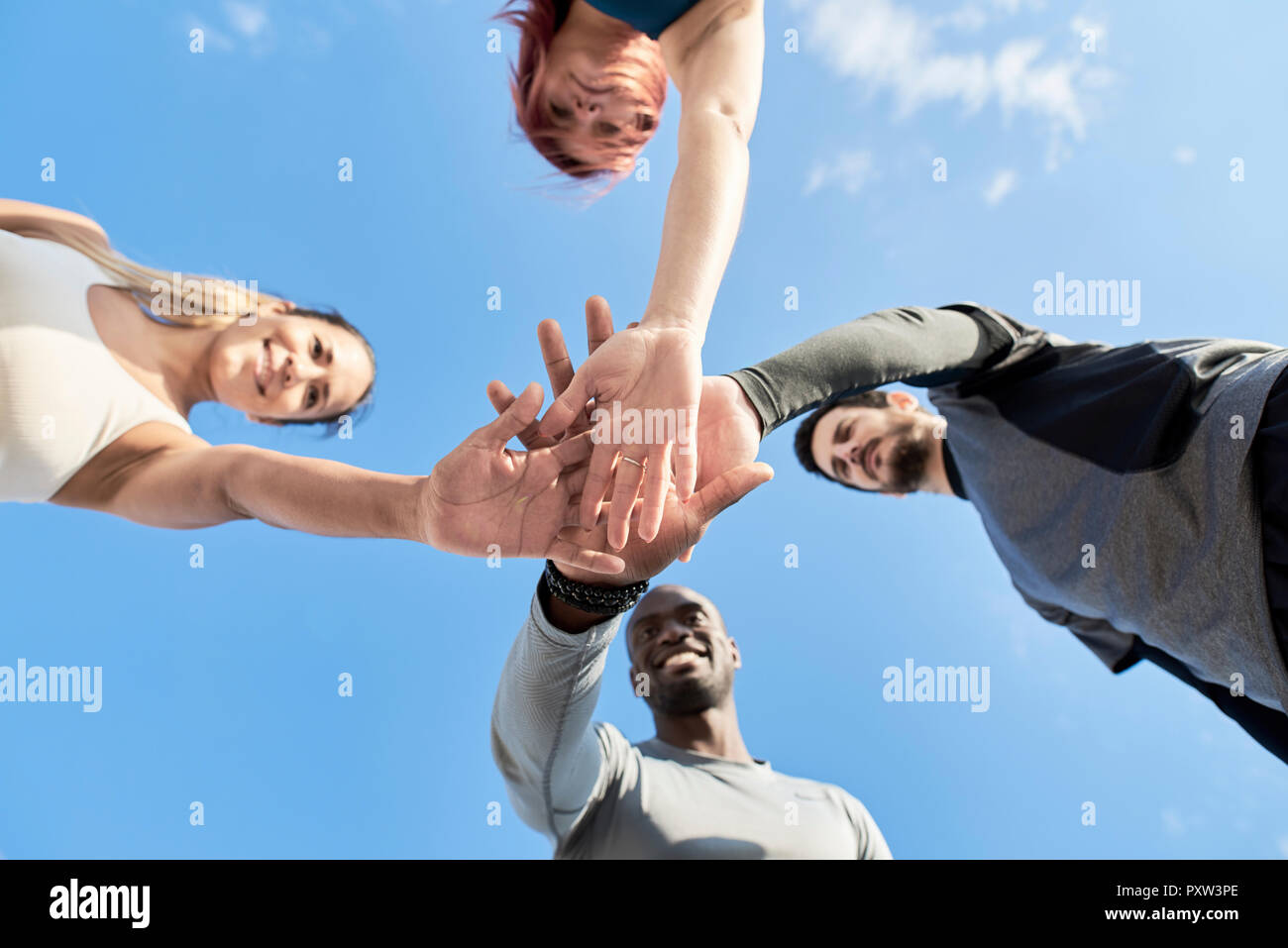 People holding hands together Stock Photo - Alamy