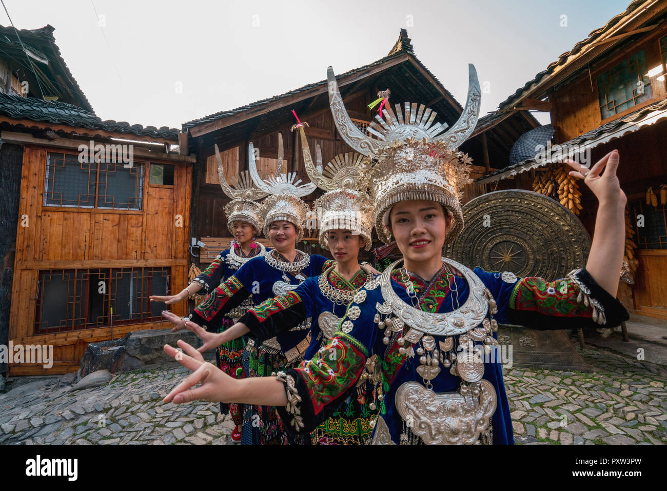 China, Guizhou, Miao women wearing traditional dresses and headdresses ...