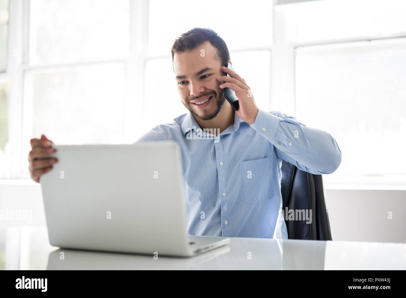 mexican attractive businessman on his 30s working at modern home office ...