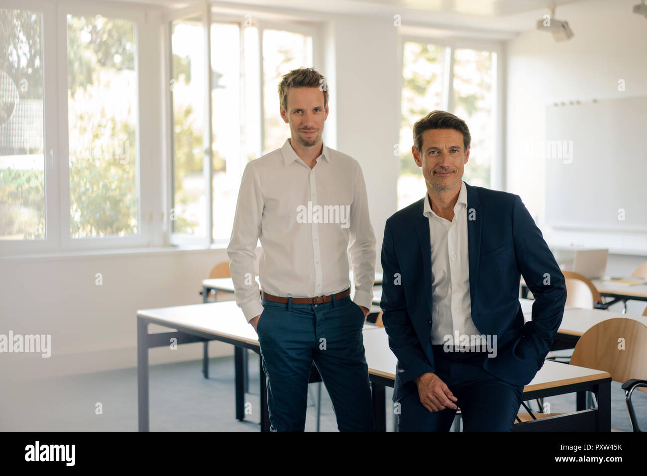 Businessmen sitting in conference room Stock Photo - Alamy