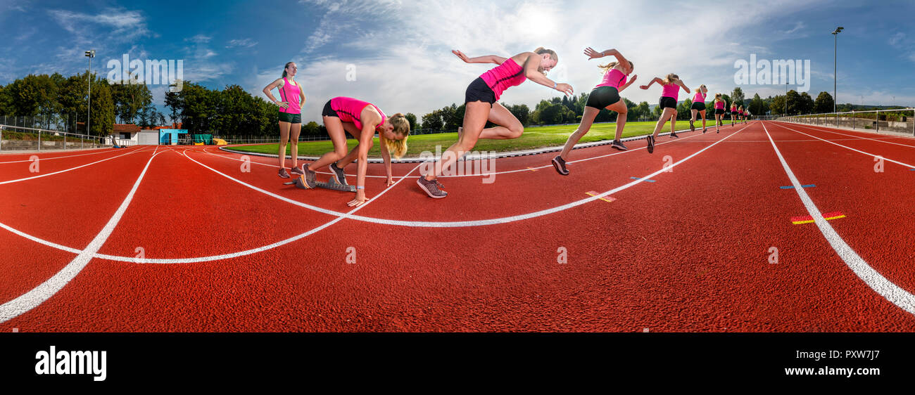 Female runner in starting position, panoramic view, phases Stock Photo ...