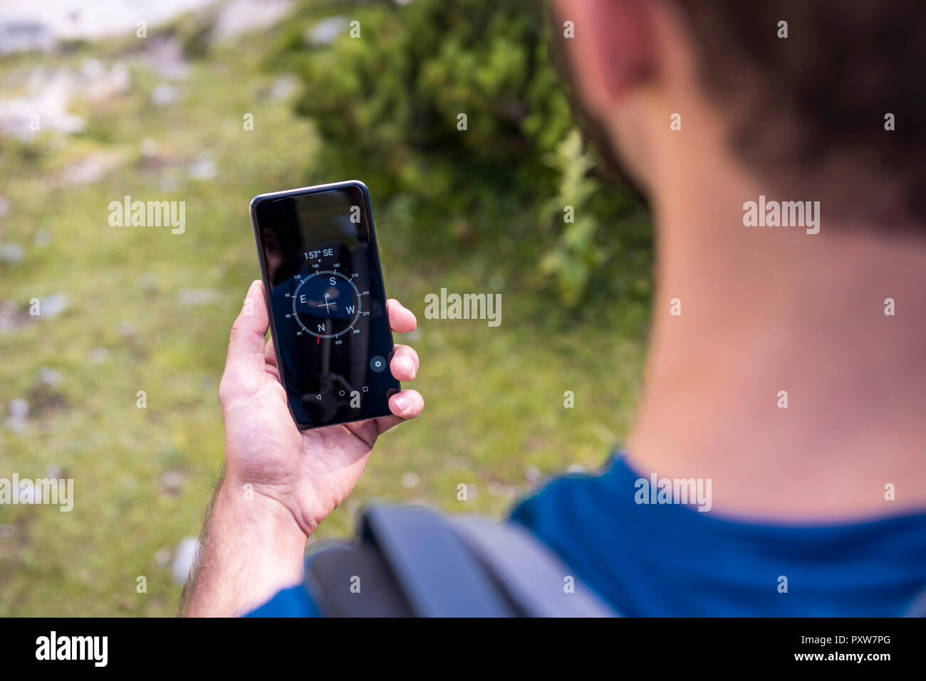 Austria, Tyrol, Hiker using compass app at Lake Seebensee Stock Photo ...