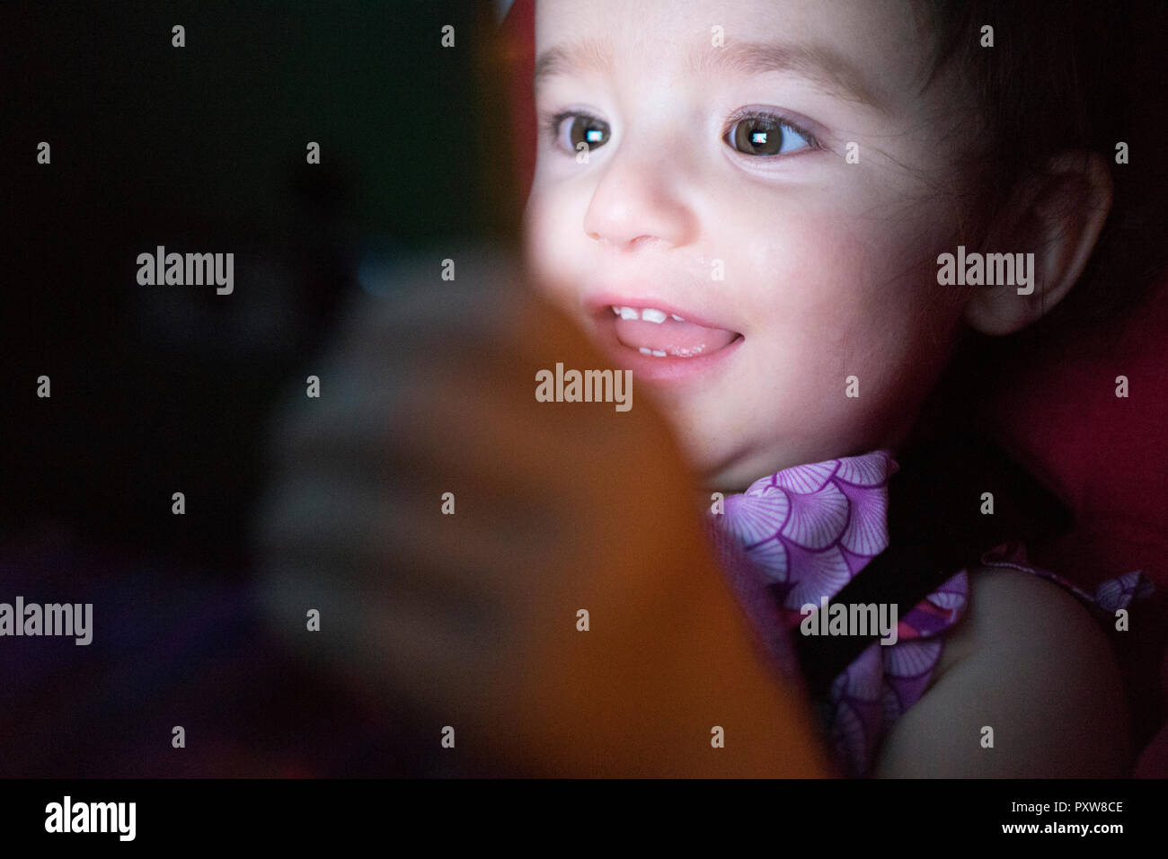Little girl watching movie on a tablet Stock Photo - Alamy