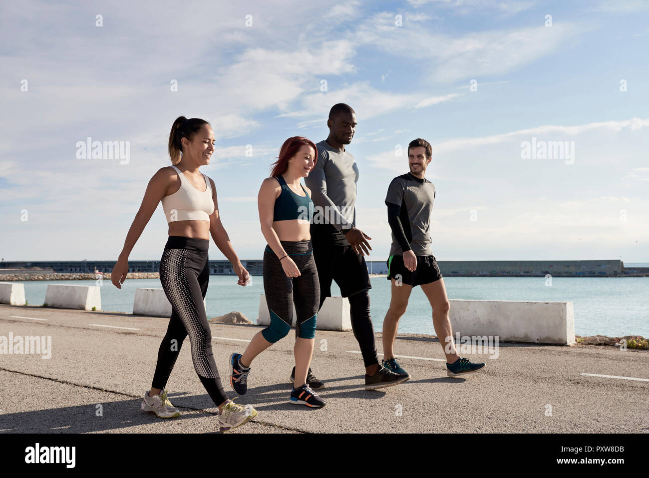 Group of sportspeople walking Stock Photo - Alamy