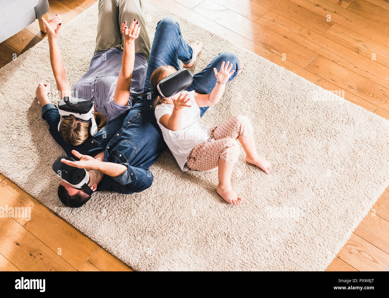 Family using VR goggles at home Stock Photo - Alamy