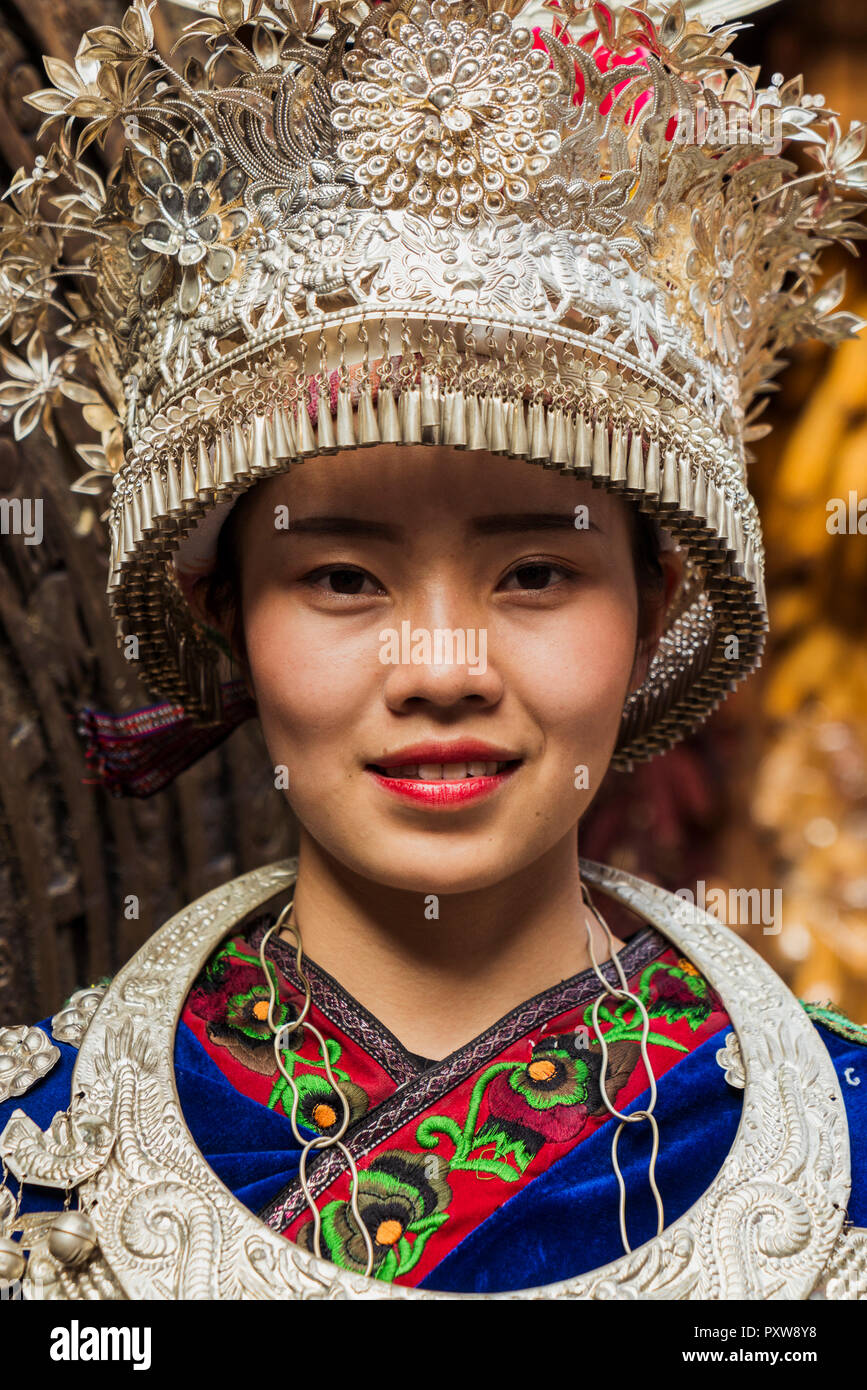 China, Guizhou, portrait of a young Miao woman wearing traditional ...