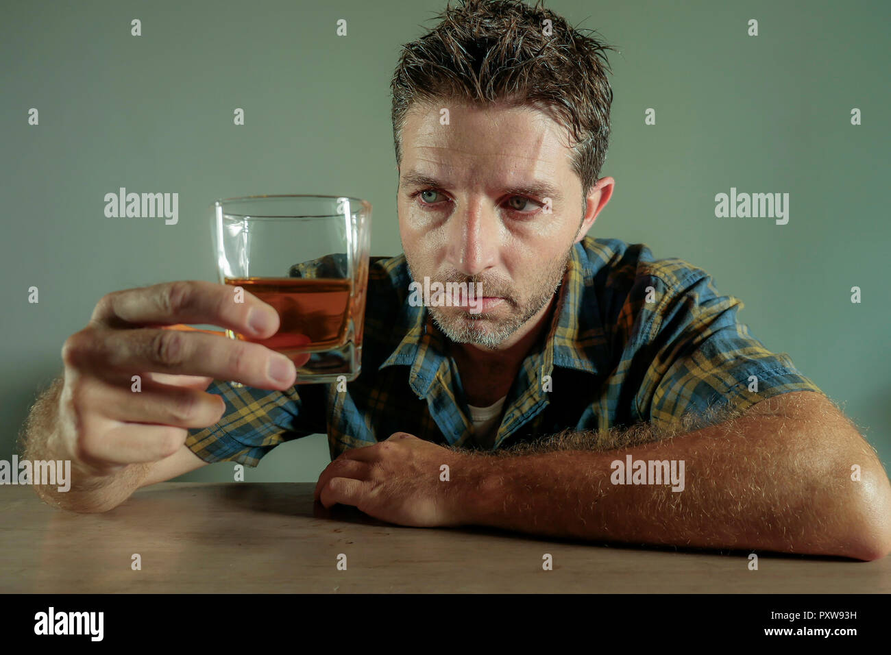 young drunk addict and alcoholic man drinking whiskey glass intoxicated ...