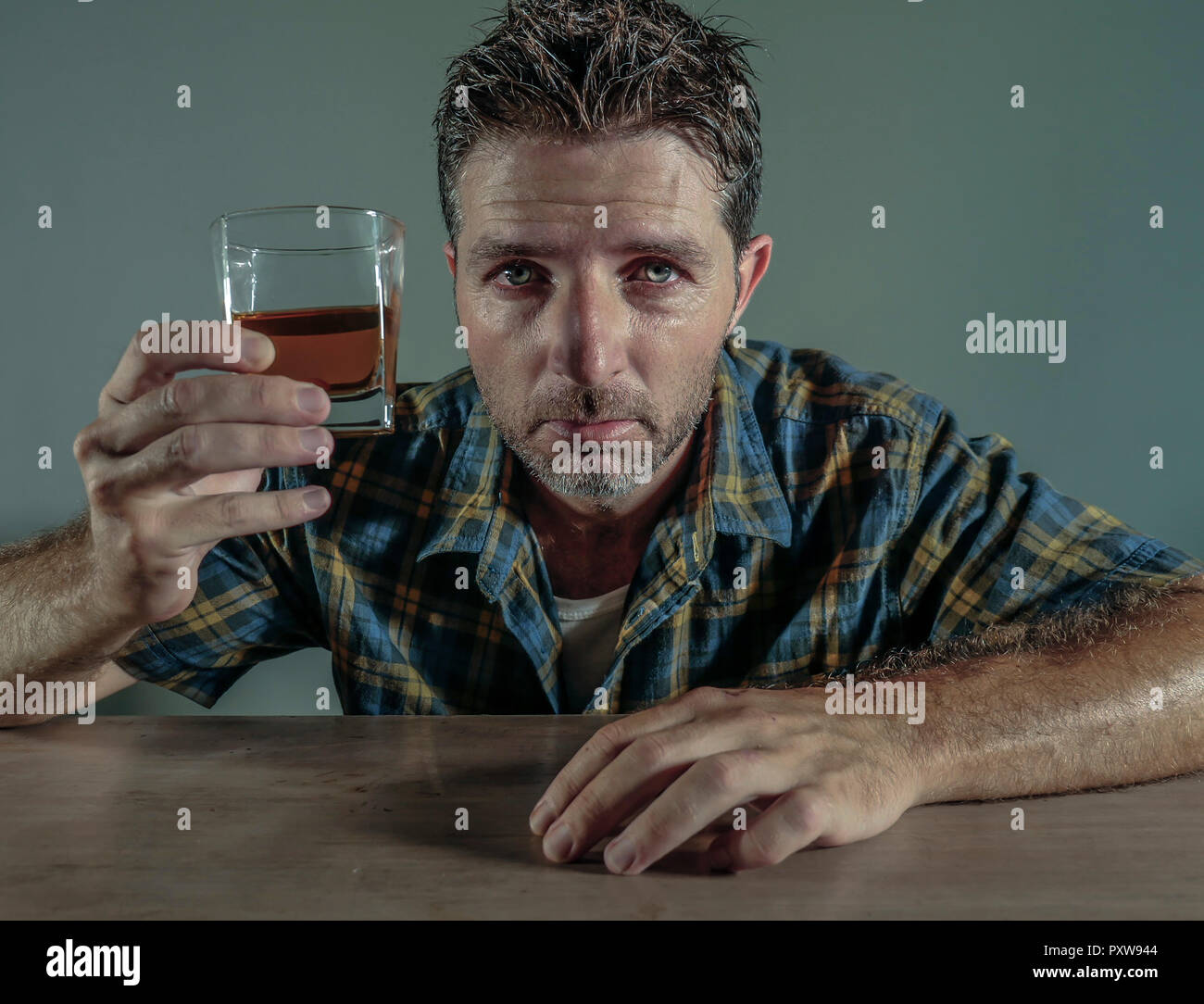young drunk addict and alcoholic man drinking whiskey glass intoxicated ...