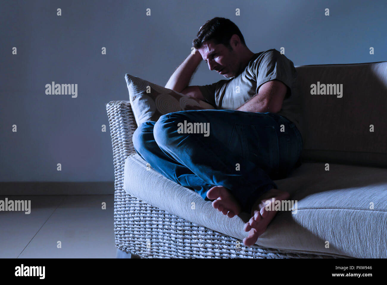 lifestyle dramatic light portrait of young sad and depressed man ...