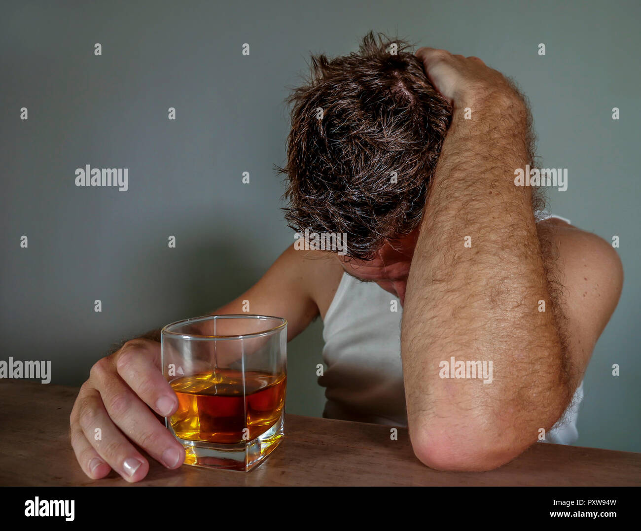 young drunk and pissed alcoholic man wasted wearing dirty singlet ...