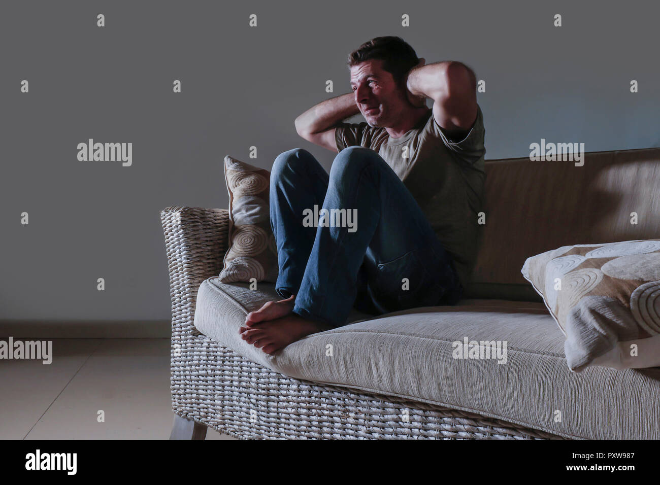 lifestyle dramatic light portrait of young sad and depressed man ...