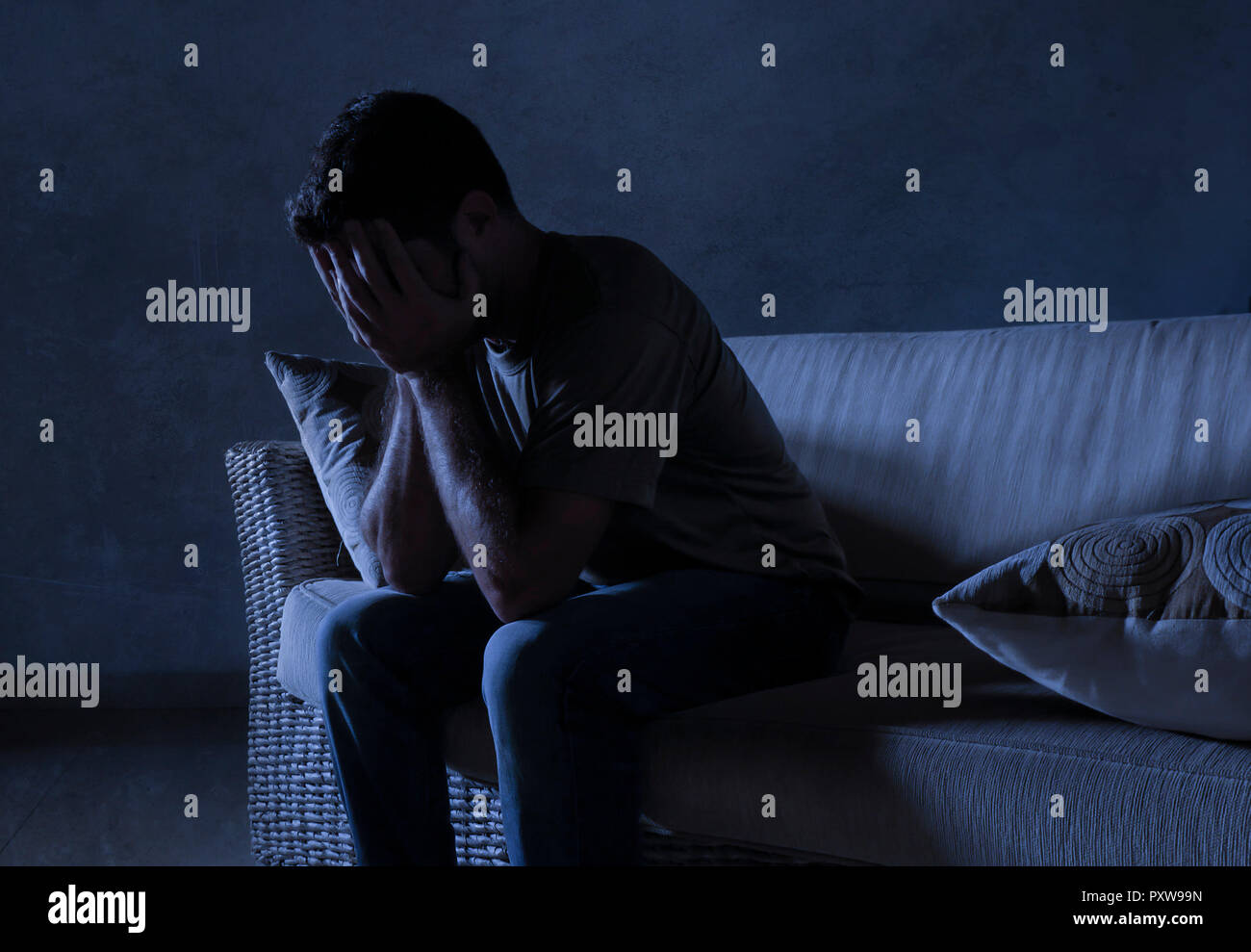 lifestyle dramatic light portrait of young sad and depressed man ...