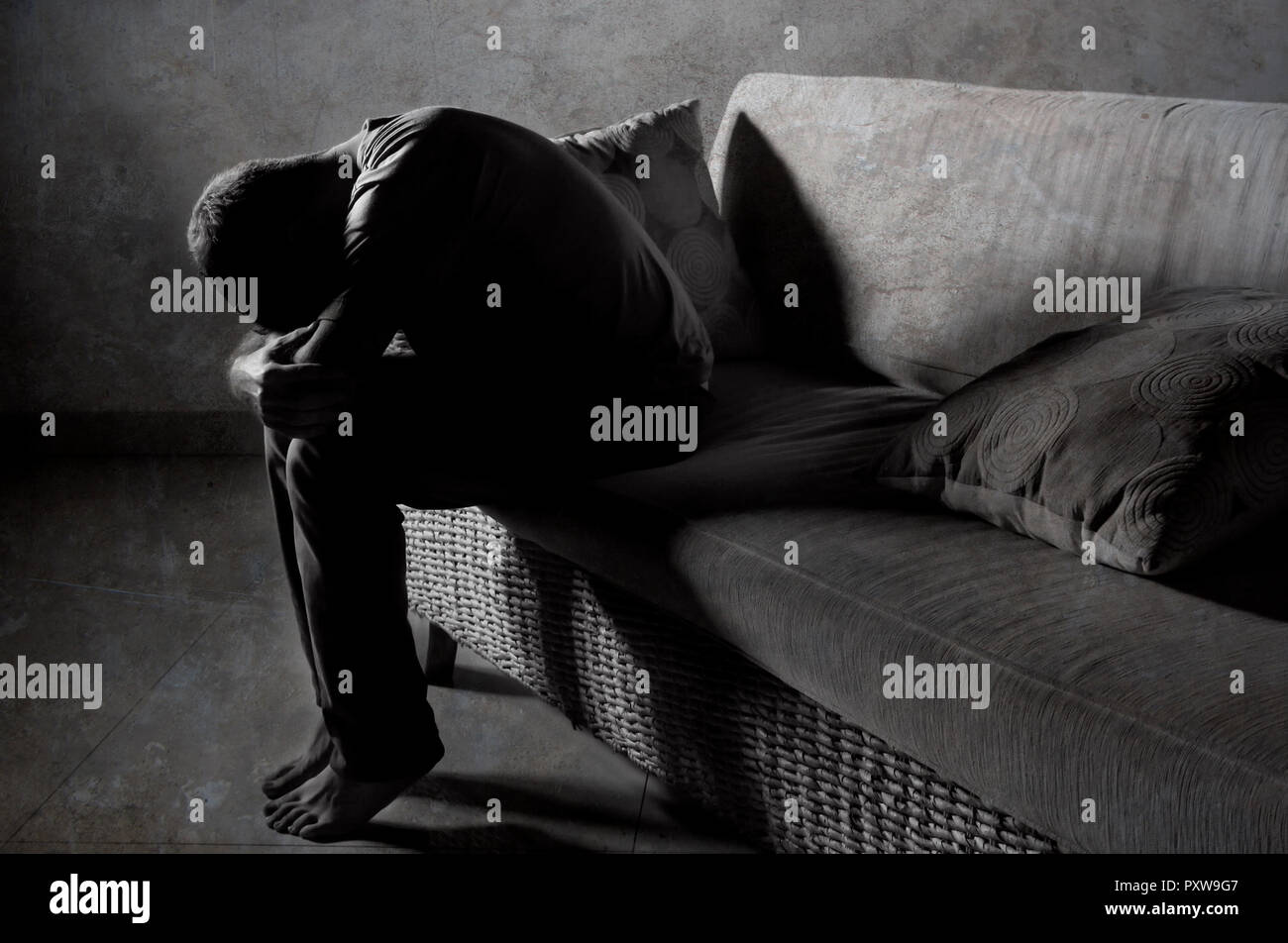 lifestyle dramatic light portrait of young sad and depressed man ...