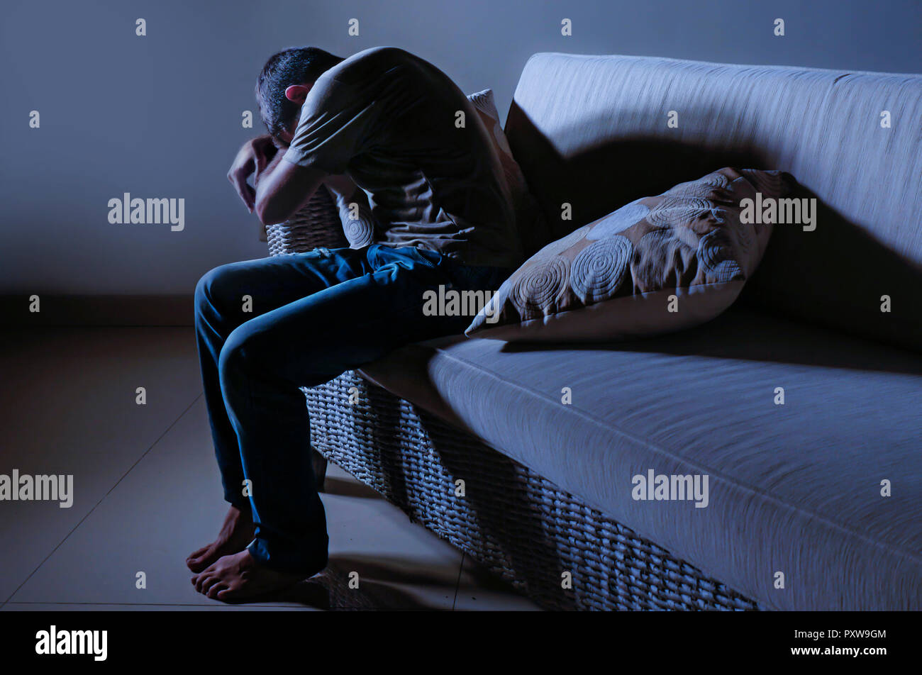lifestyle dramatic light portrait of young sad and depressed man ...