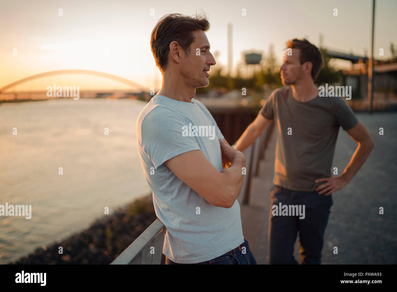 Two male friends talking outdoors hi-res stock photography and images ...